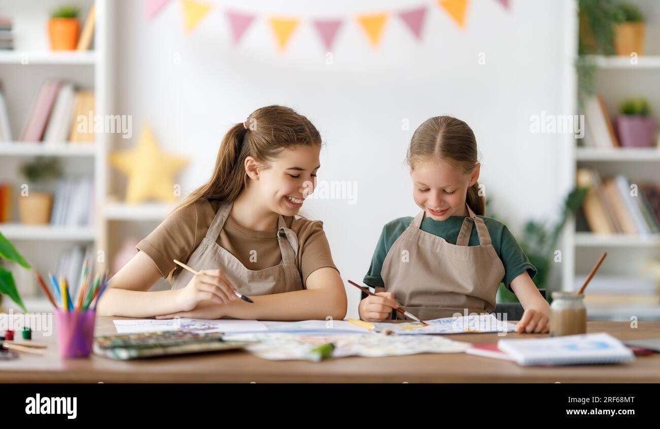 Happy kids at the art class. Children are painting together Stock Photo ...