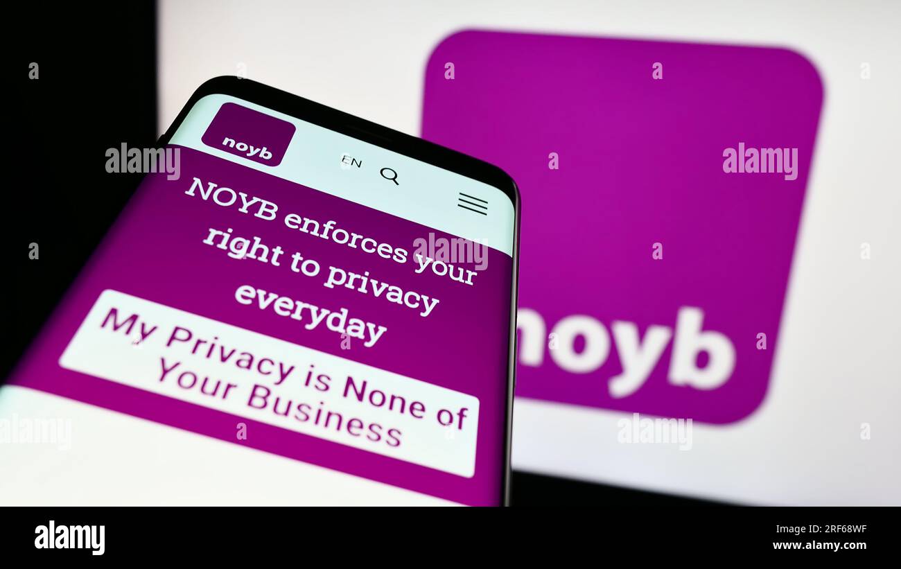 Smartphone with website of NOYB – European Center for Digital Rights on screen in front of logo ...