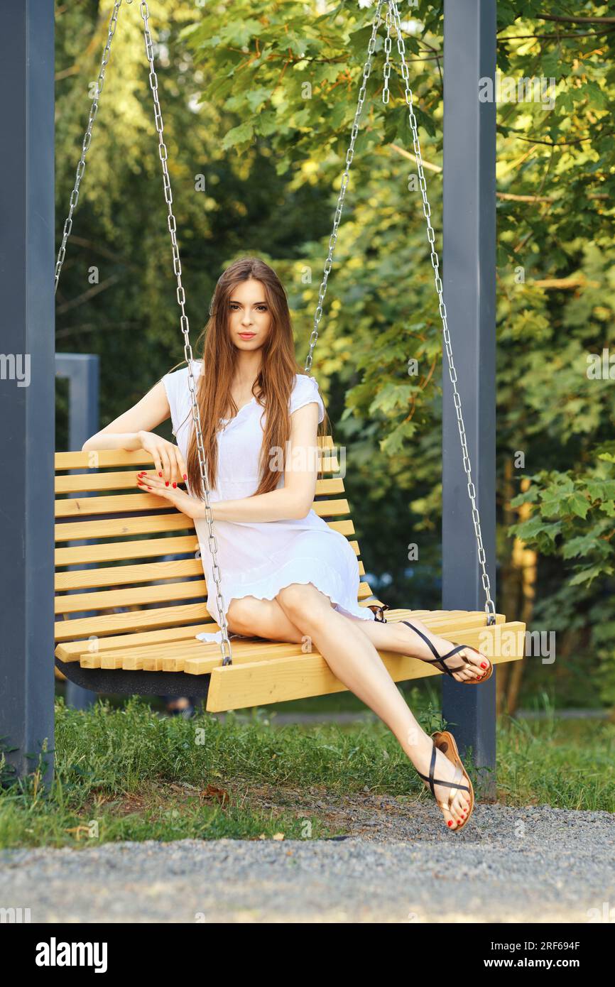 Portrait woman sitting on swing hi-res stock photography and images - Alamy