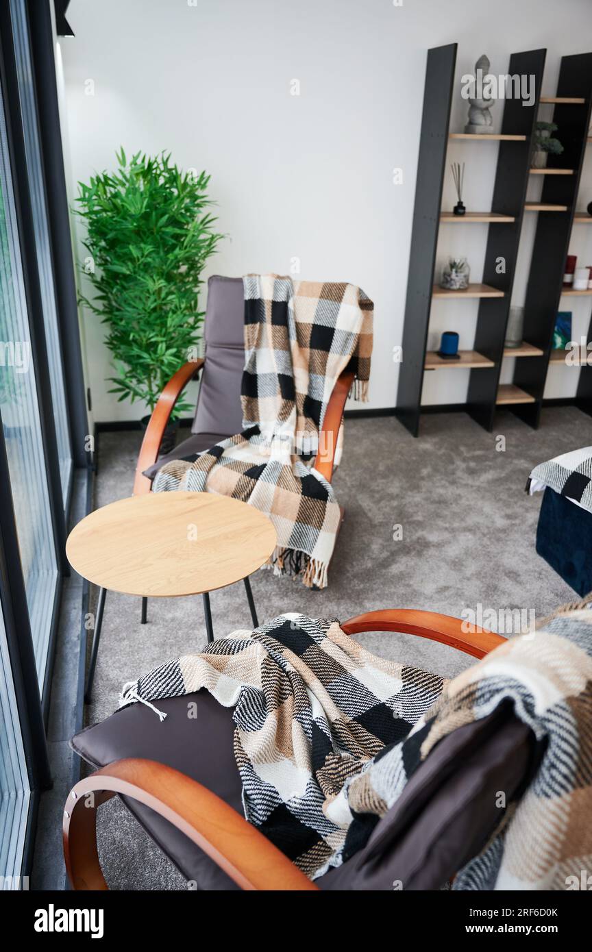 Modern living room with coffee table and armchairs for resting indoor ...