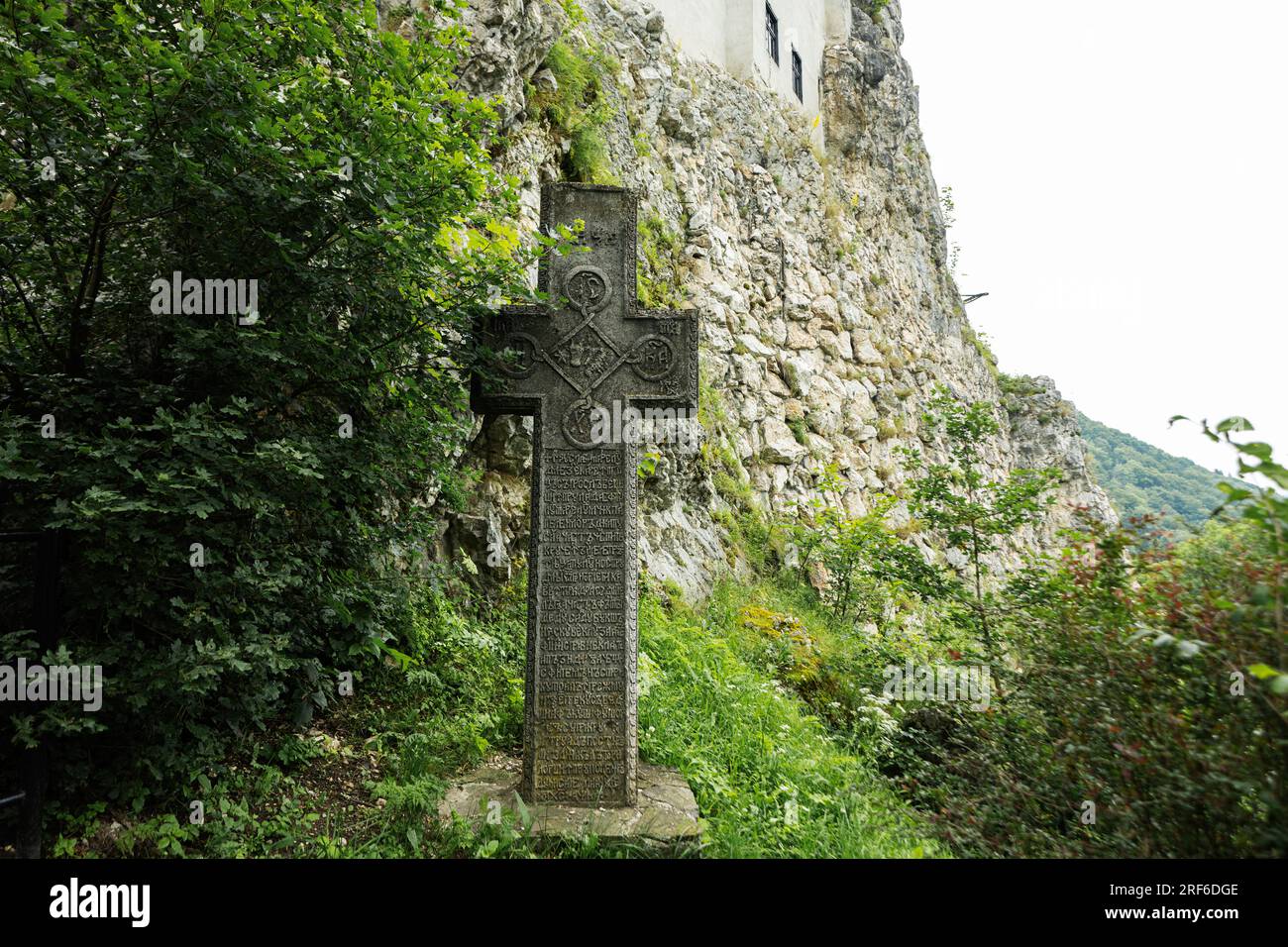Old srone croos against Bran Castle in Romania. Dracula medieval castle ...