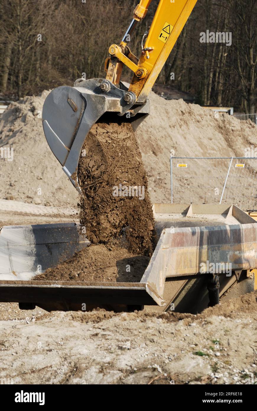 Digger filling sand in a lorry Stock Photo - Alamy