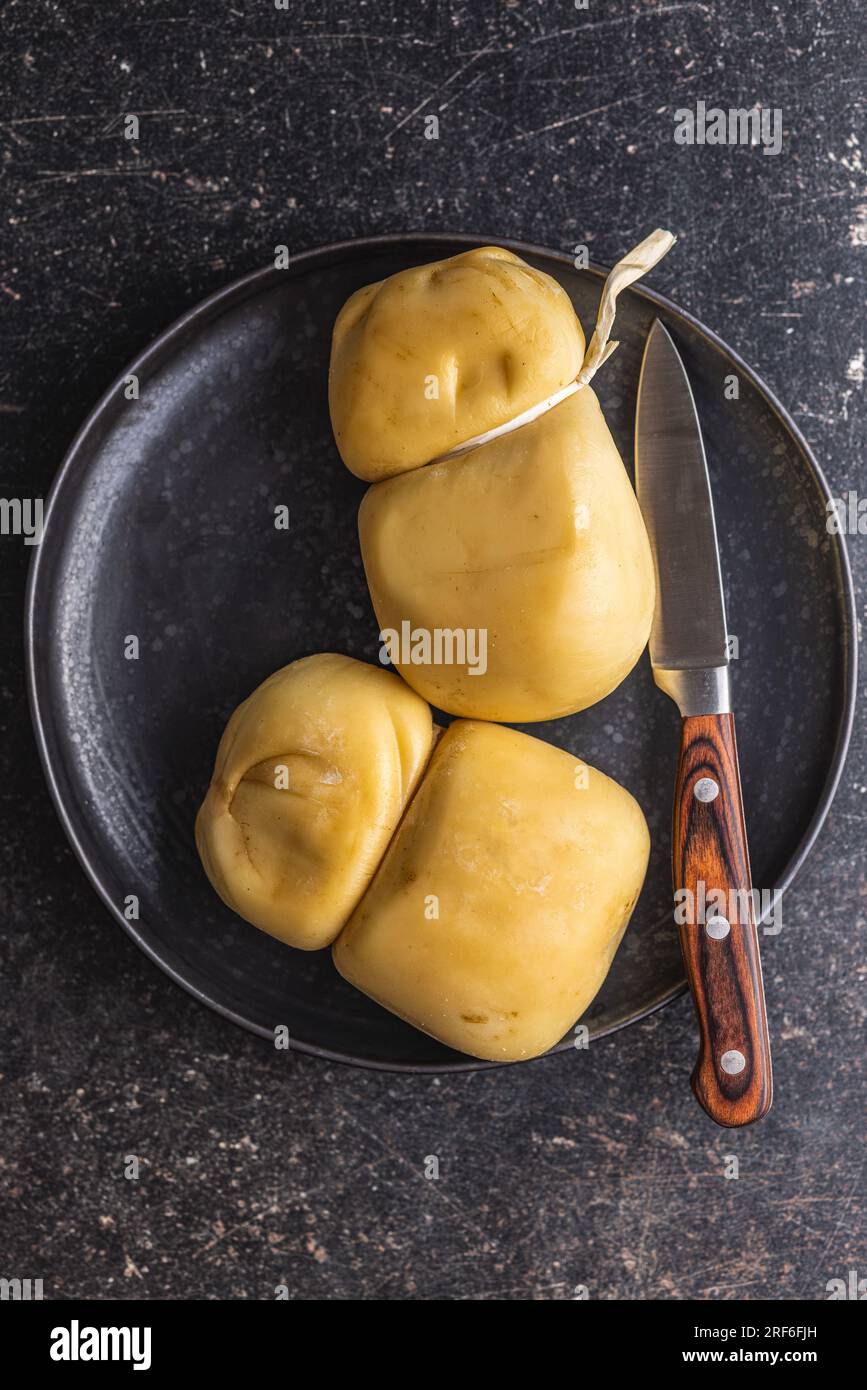 Smoked scamorza cheese on the plate. Top view Stock Photo - Alamy