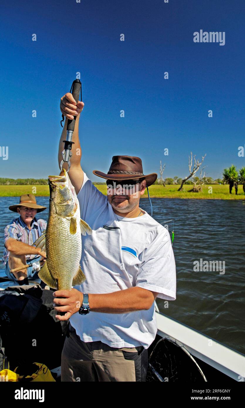 Angler with barramundi (Lates calcarifer) Kakadu National Park ...