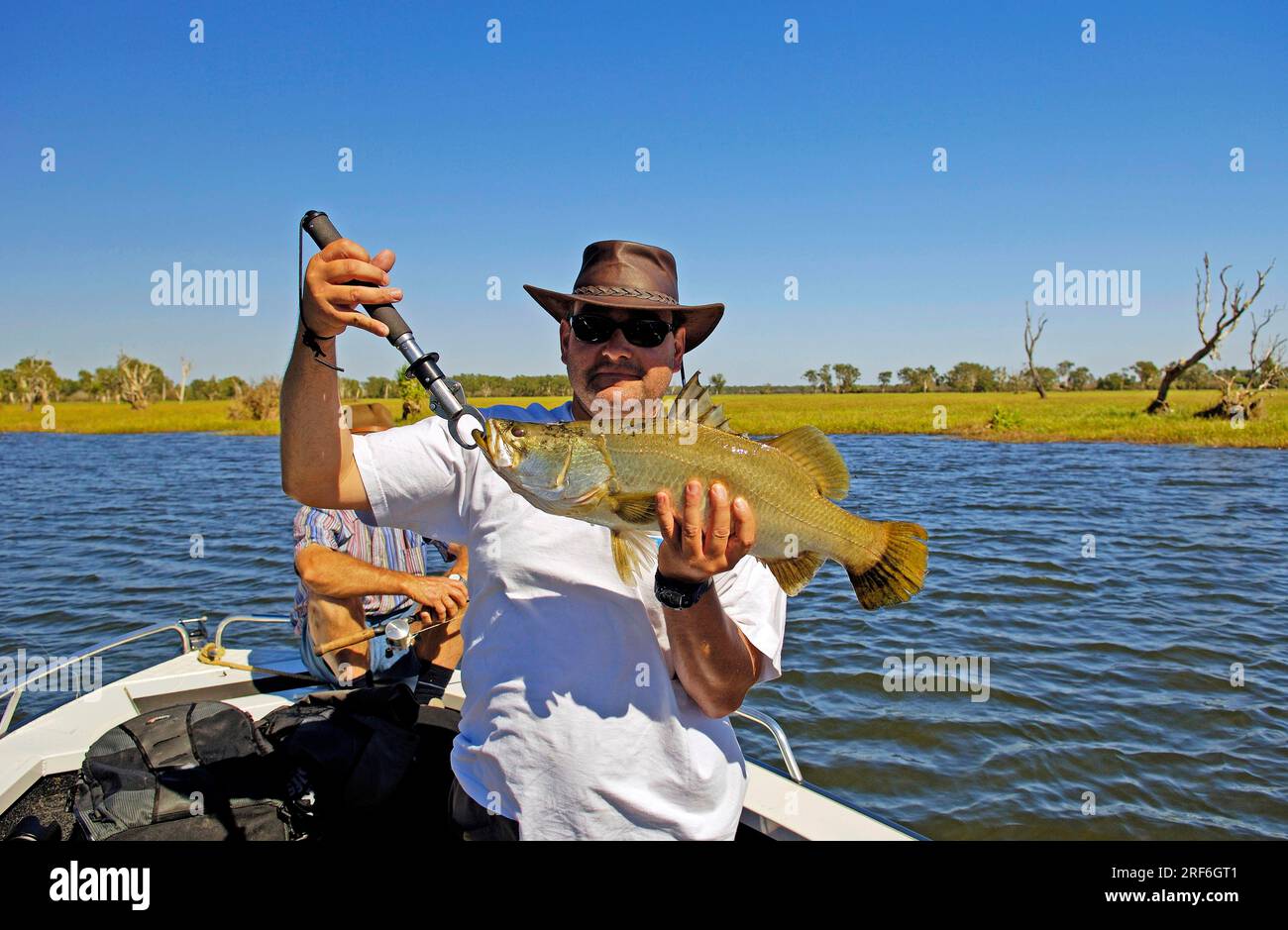 Angler with Barramundi (Lates calcarifer), Kakadu national park ...