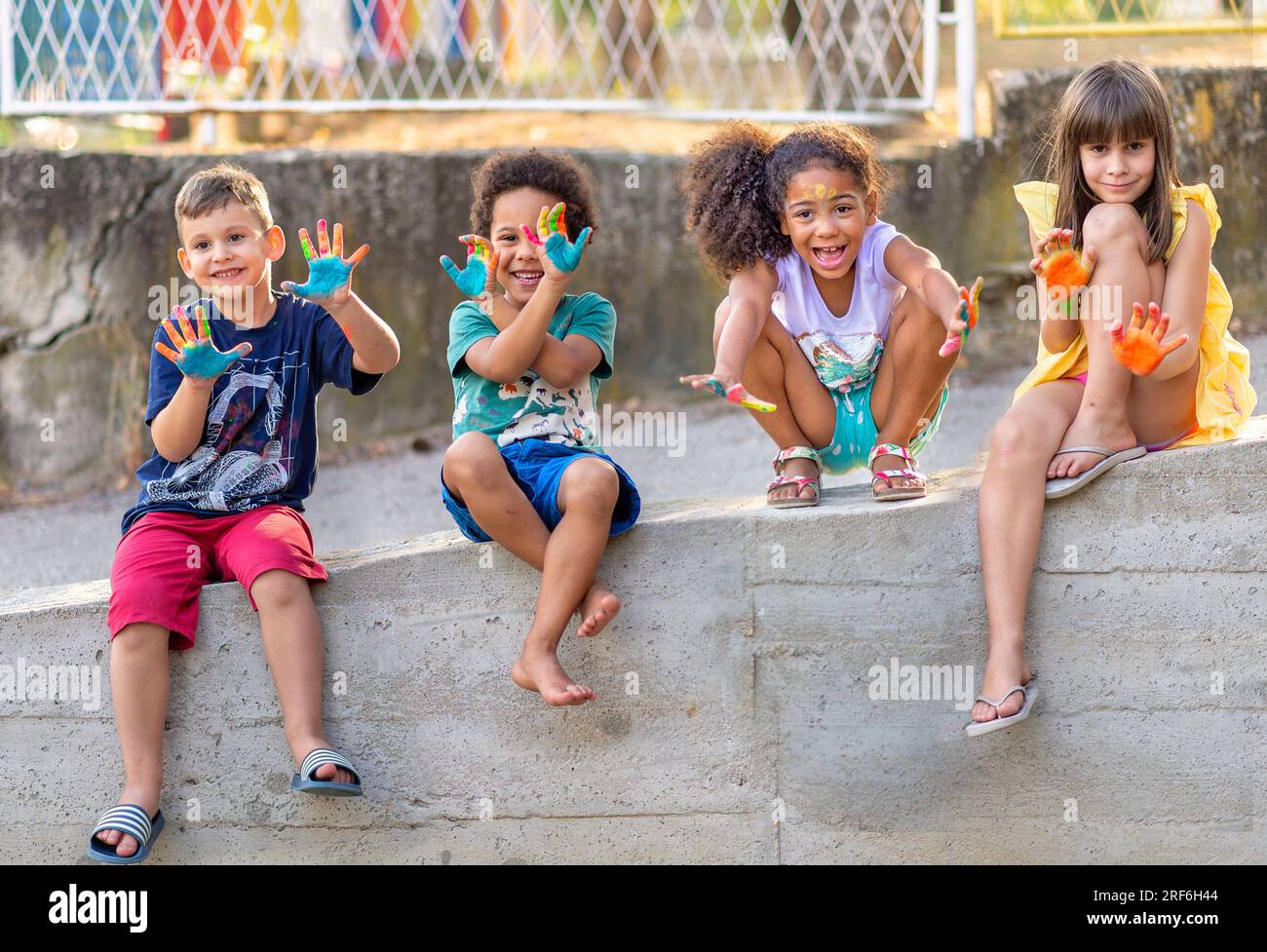 group of cheerful multicultural children playing together, showing ...