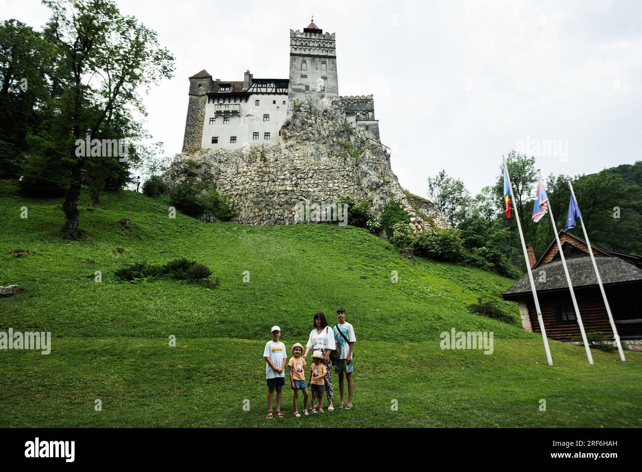 Family tourists against Bran Castle in Romania. Dracula medieval castle ...