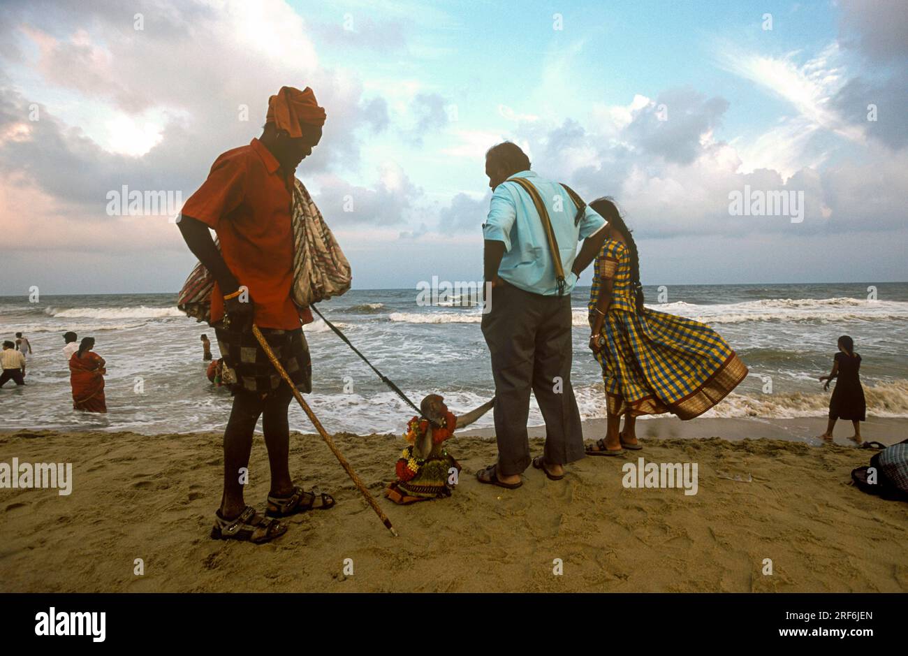 Monkey charmer monkey Playing tourist on the beach in Mahabalipuram ...