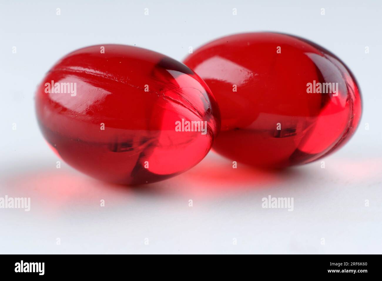 Red oil capsules, red oil capsule, clipping, object Stock Photo - Alamy