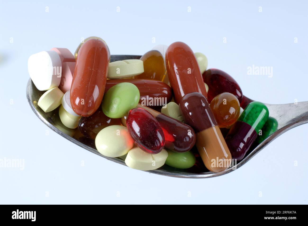Spoon with tablets, pills, capsules, cut-out, object Stock Photo - Alamy
