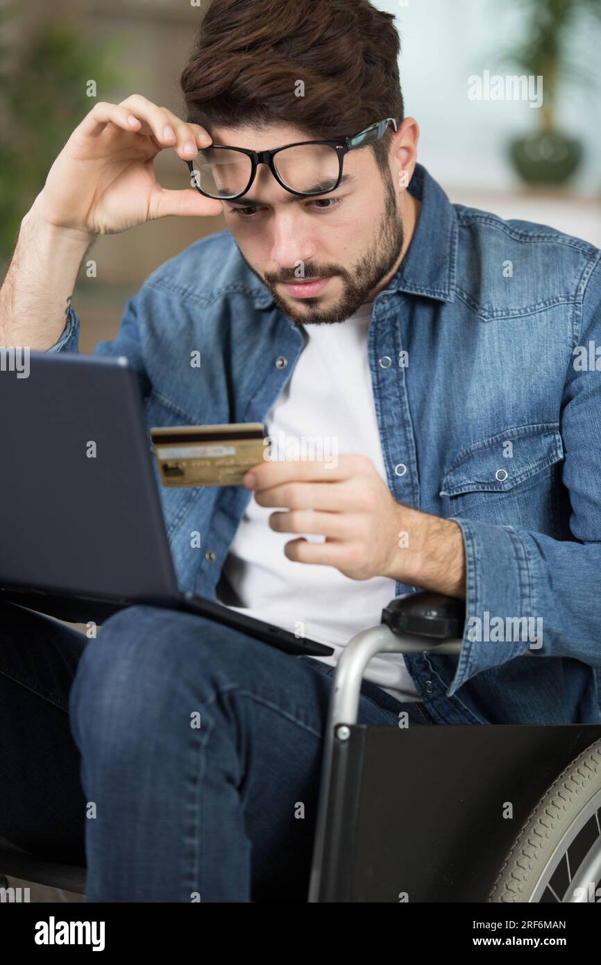 disabled person reads credit card and uses pc Stock Photo - Alamy