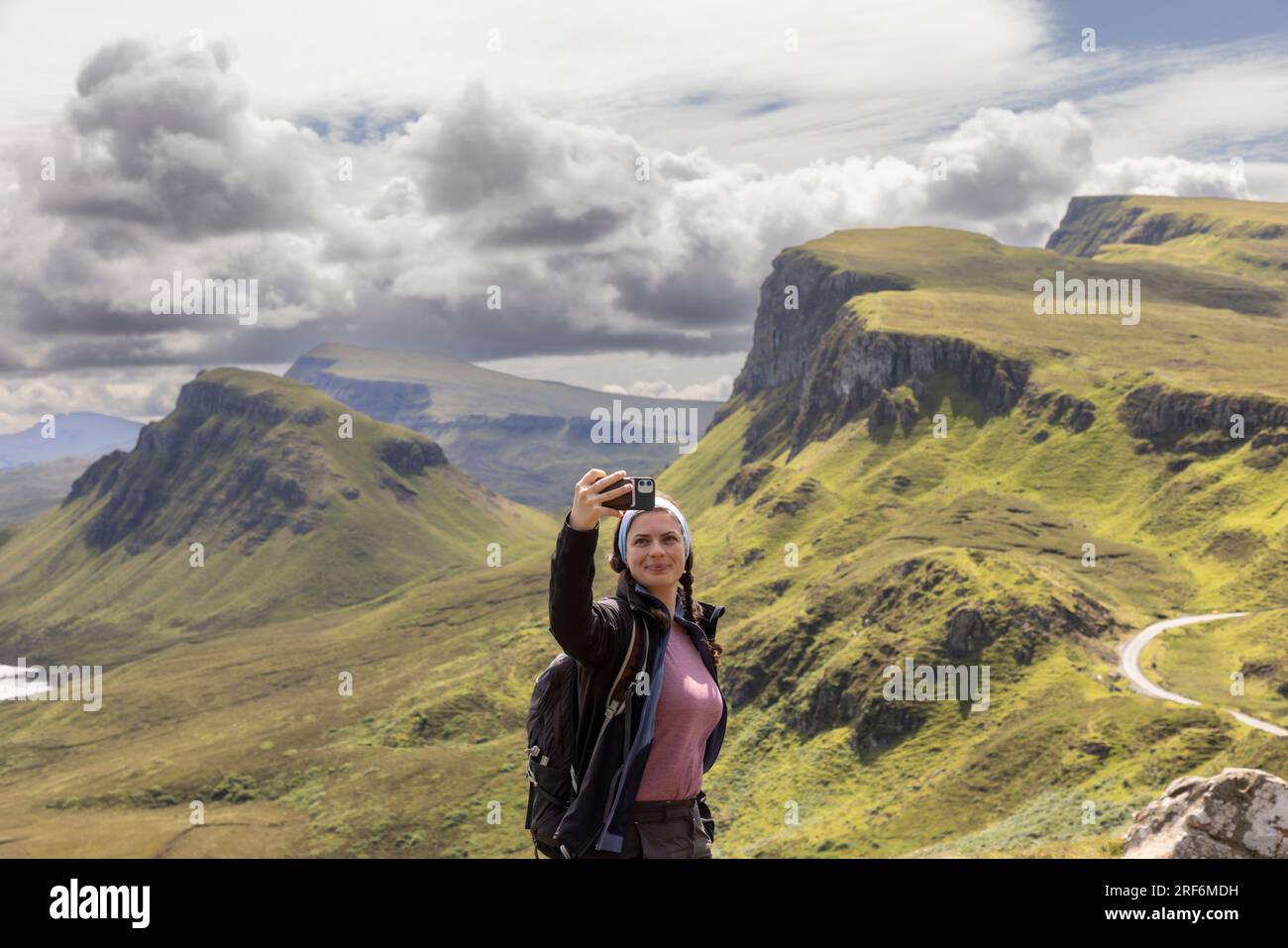 Young woman making selfie with smartphone on mountain range Quiraing ...