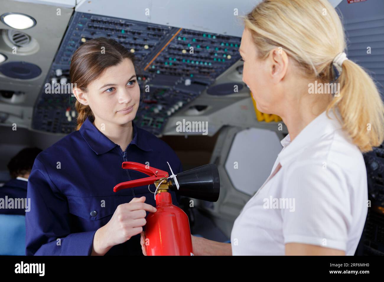 women and fire extinguisher concept Stock Photo - Alamy