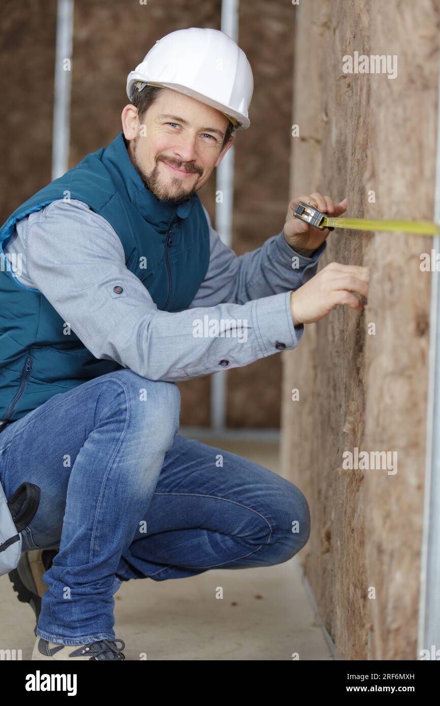 construction worker using measuring tape Stock Photo - Alamy