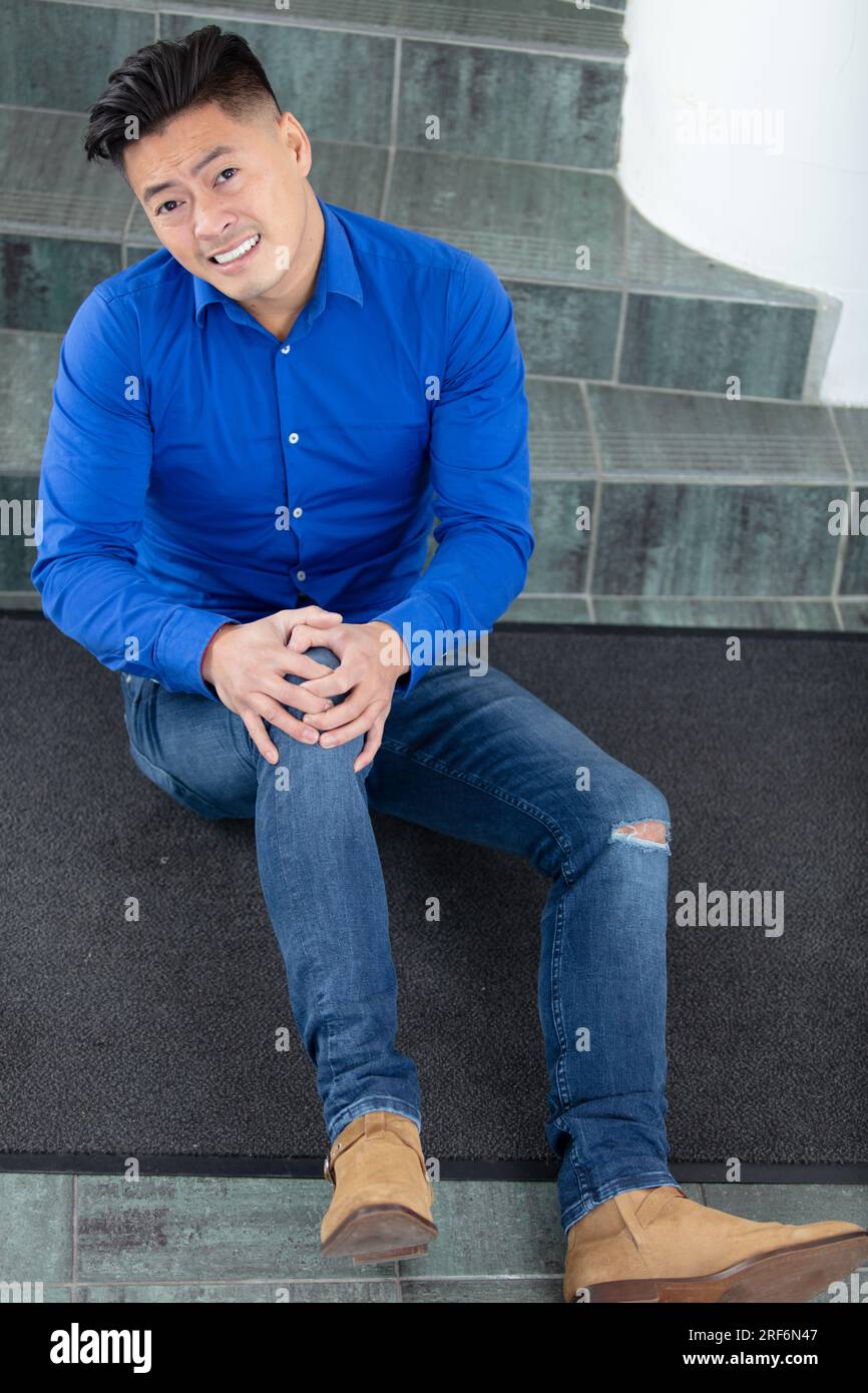 mature man lying on staircase after slip and fall accident Stock Photo ...