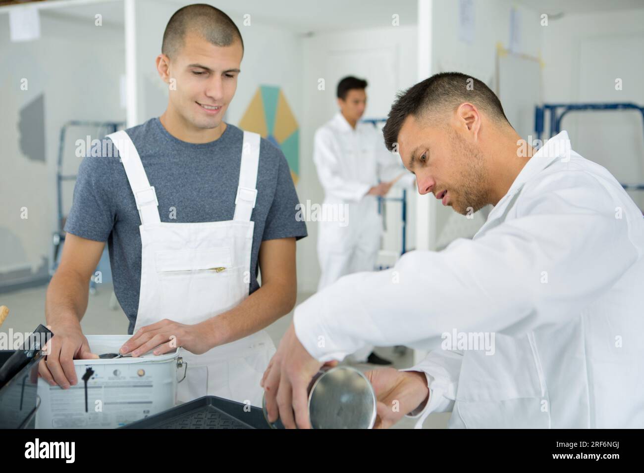 commercial painting apprentice and teacher Stock Photo - Alamy