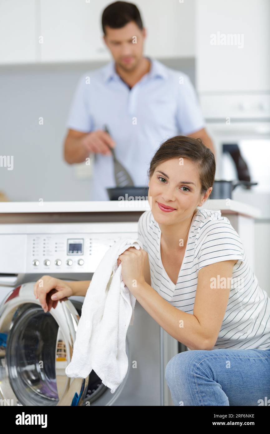 Woman using washing machine hi-res stock photography and images - Alamy