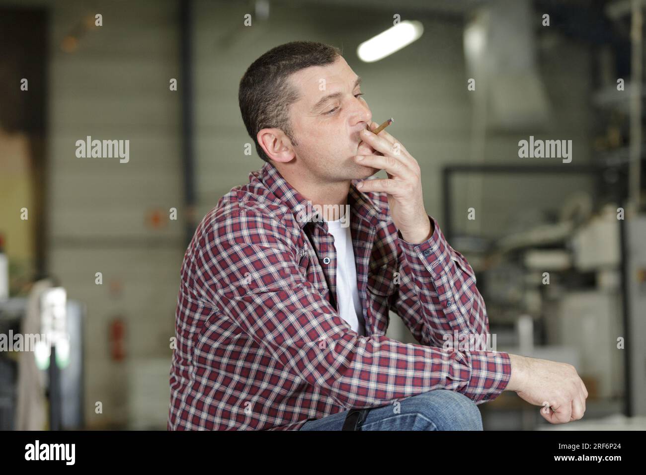 Construction worker smokes cigarette hi-res stock photography and ...