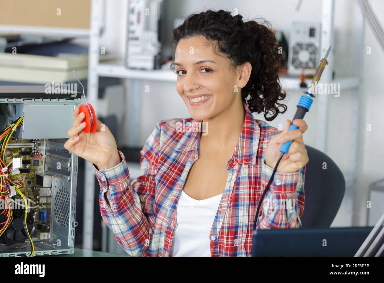 female pc technician soldering a chip from a desktop computer Stock Photo - Alamy
