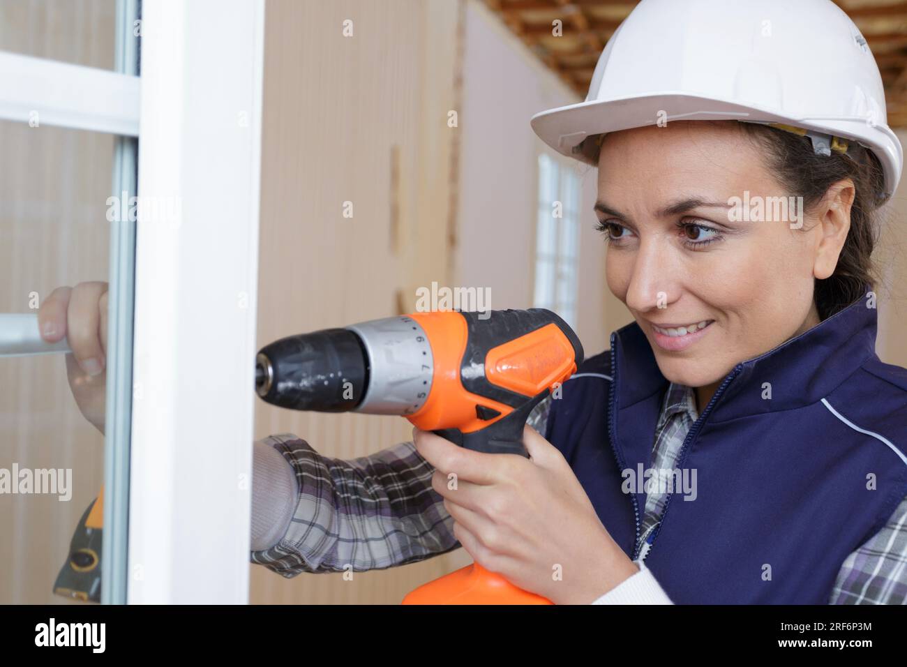 construction worker drilling a window Stock Photo - Alamy