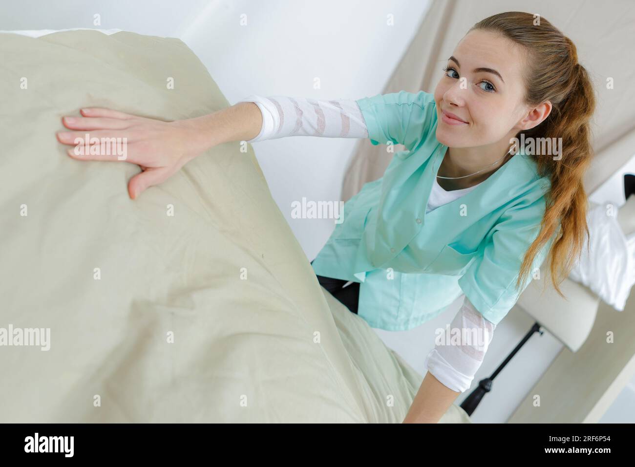 portrait of a positive minded lady making a bed Stock Photo - Alamy