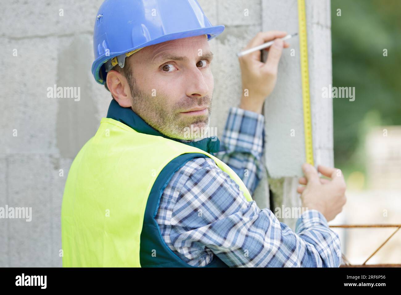 construction worker with measuring tool Stock Photo - Alamy