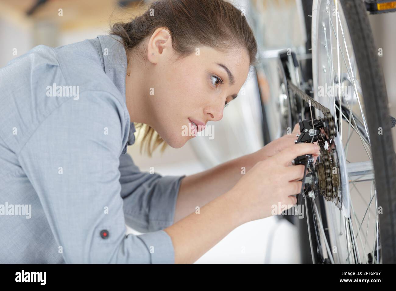 Female bike mechanic repairing hi-res stock photography and images - Alamy
