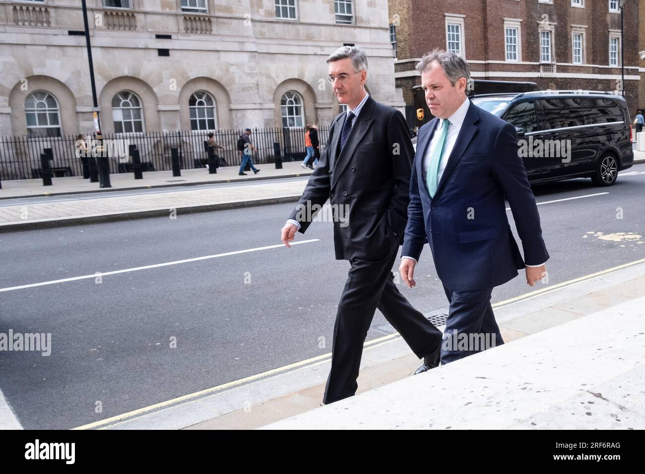 Conservative MPs Jacob Rees-Mogg (left) and Edward Argar walking past ...