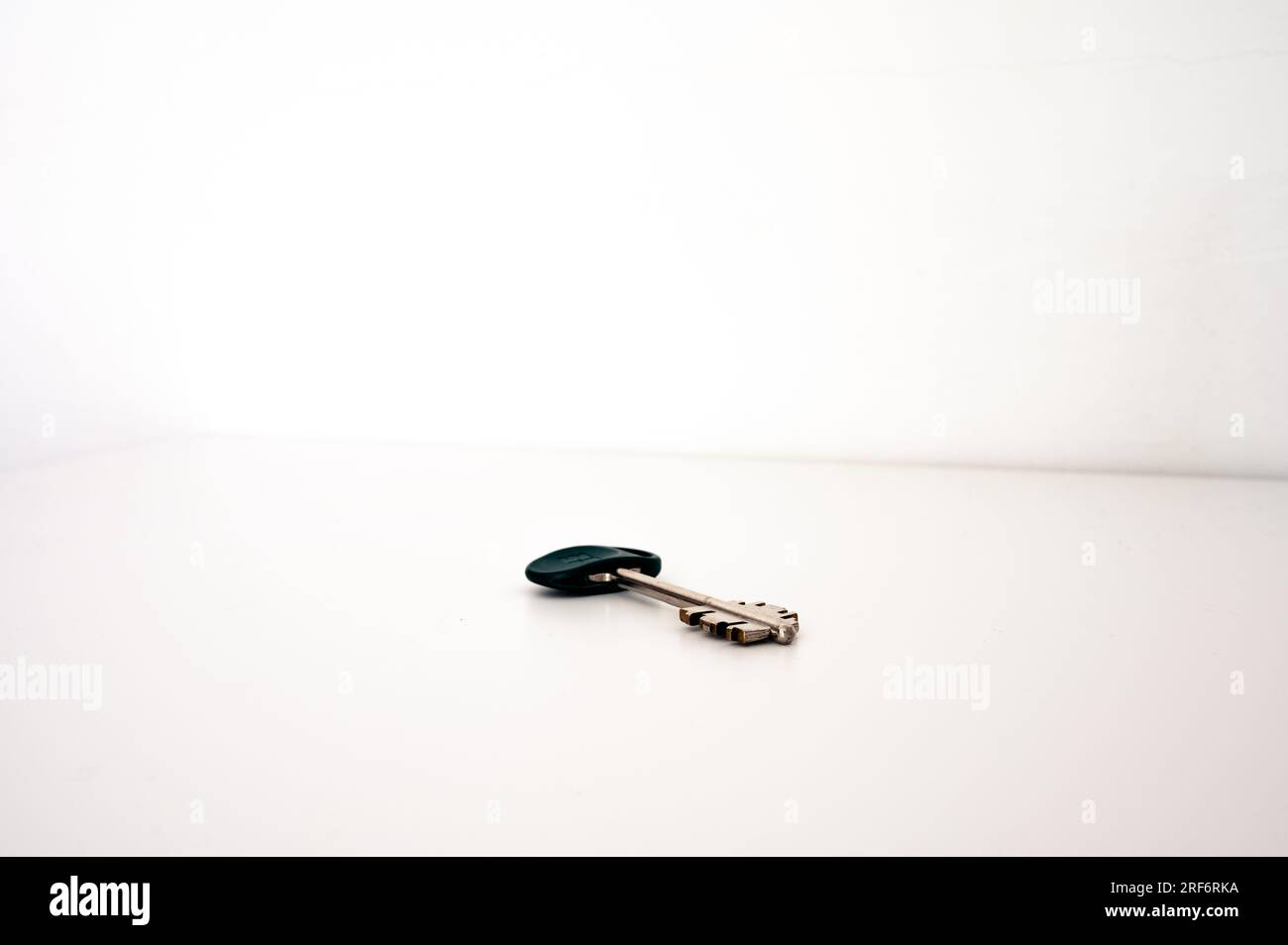 One metal key with white background Stock Photo - Alamy