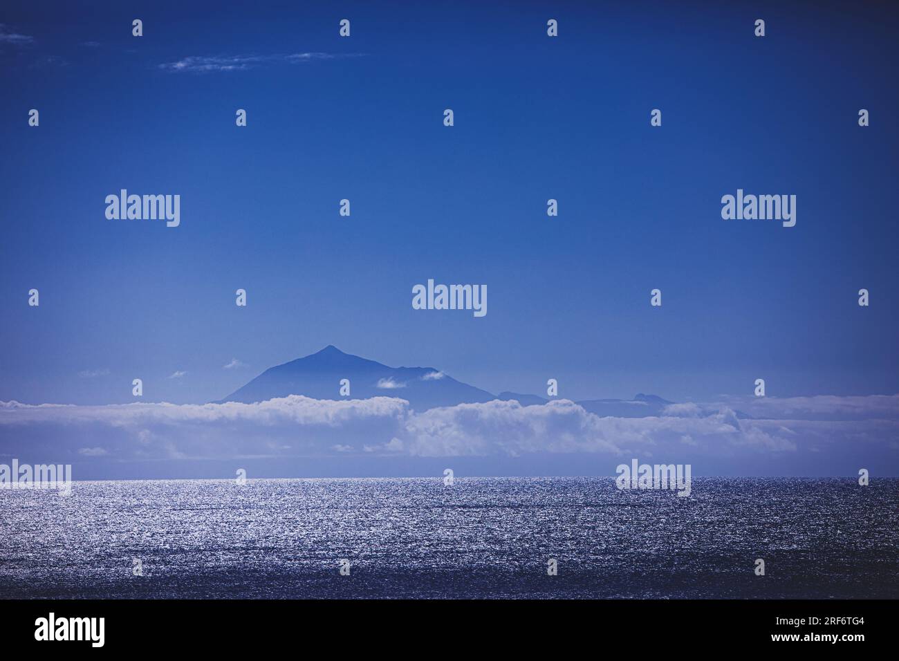 Blue silhouette with ocean and clouds of the volcano Teide (Tenerife ...
