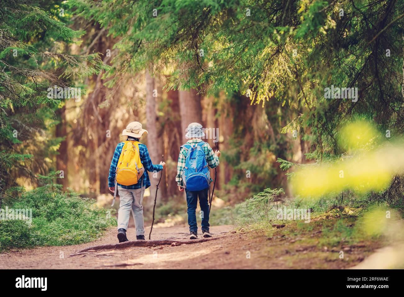 Two boys walking backpacks hi-res stock photography and images - Alamy