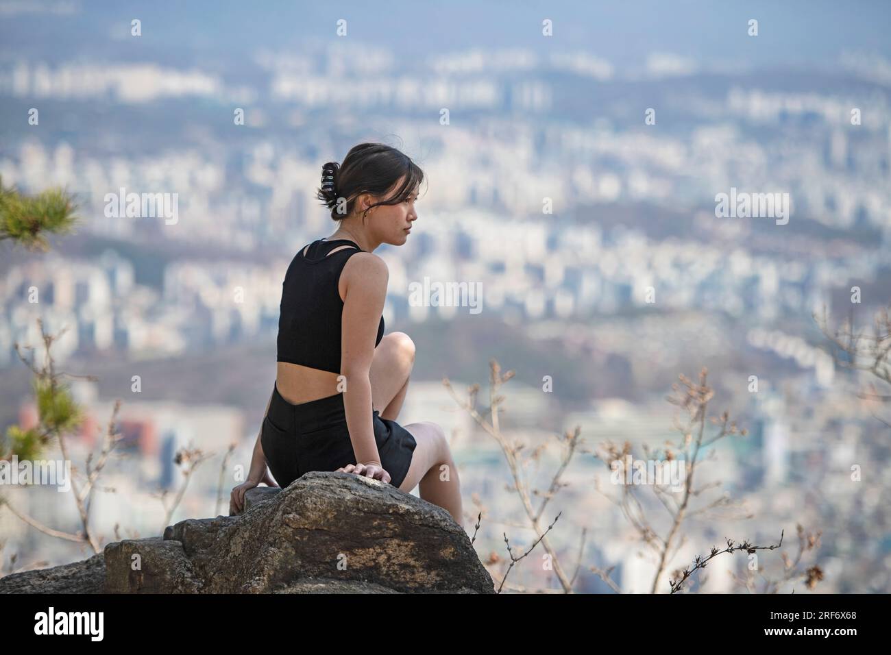 young woman sitting on rock in Buk Han san, mountain range north of ...