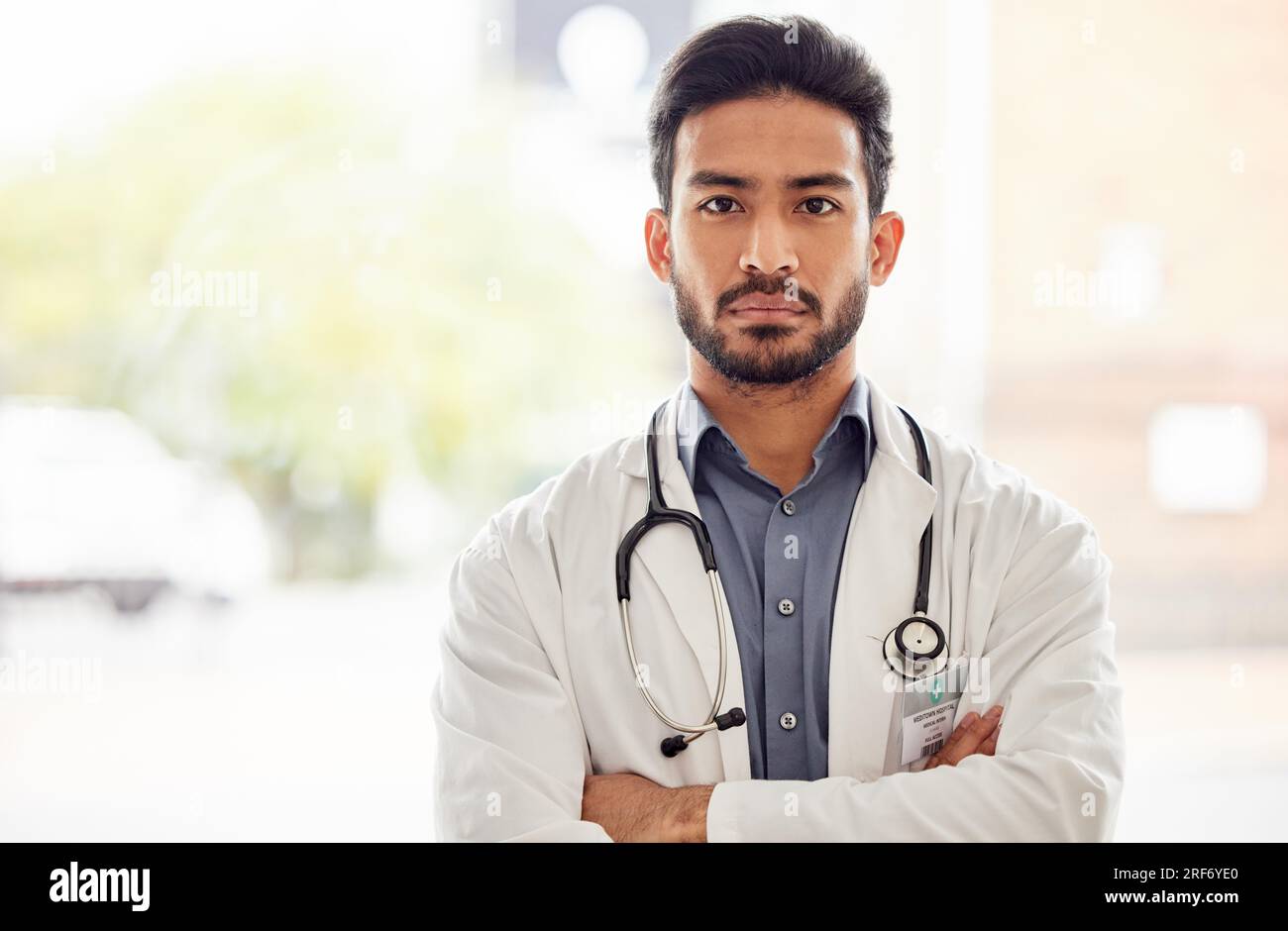 Serious, arms crossed and man doctor portrait in hospital with ...