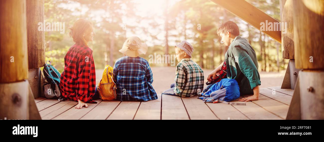 Family of four sitting in nature for resting after long hiking Stock ...