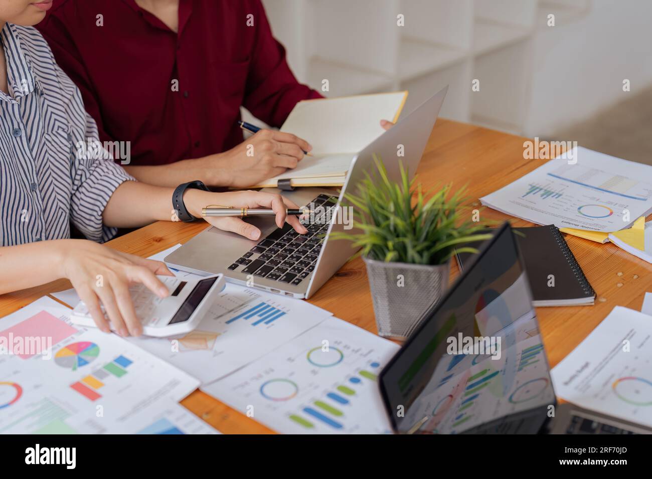 Businesswoman using a calculator to calculate numbers on a company's ...
