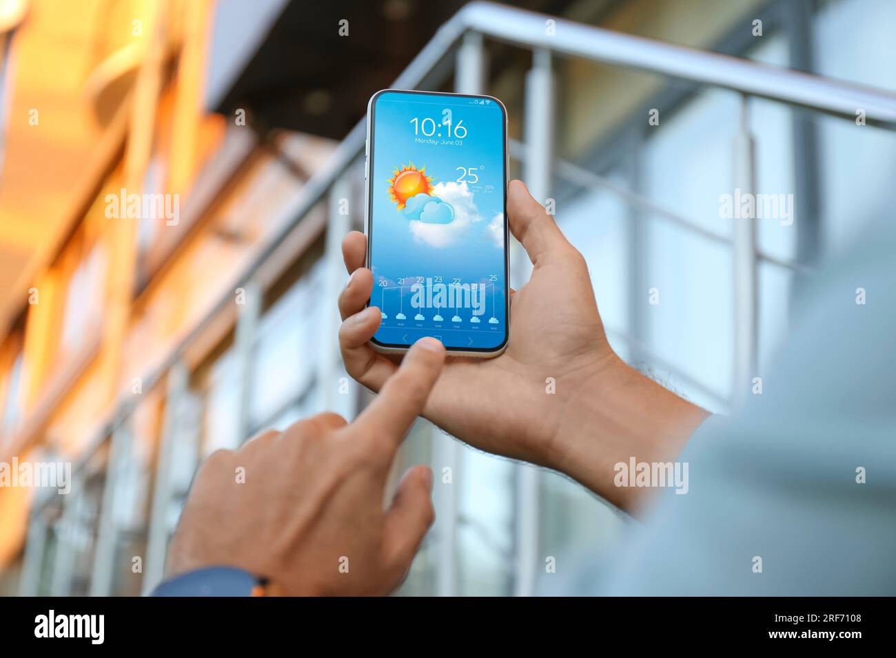 Man checking weather using app on smartphone outdoors, closeup. Data ...