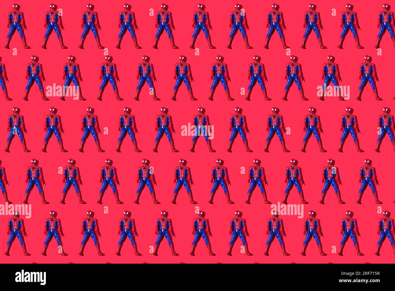 Pattern of Marvel and Sony spiderman dolls on a red background. Comic ...