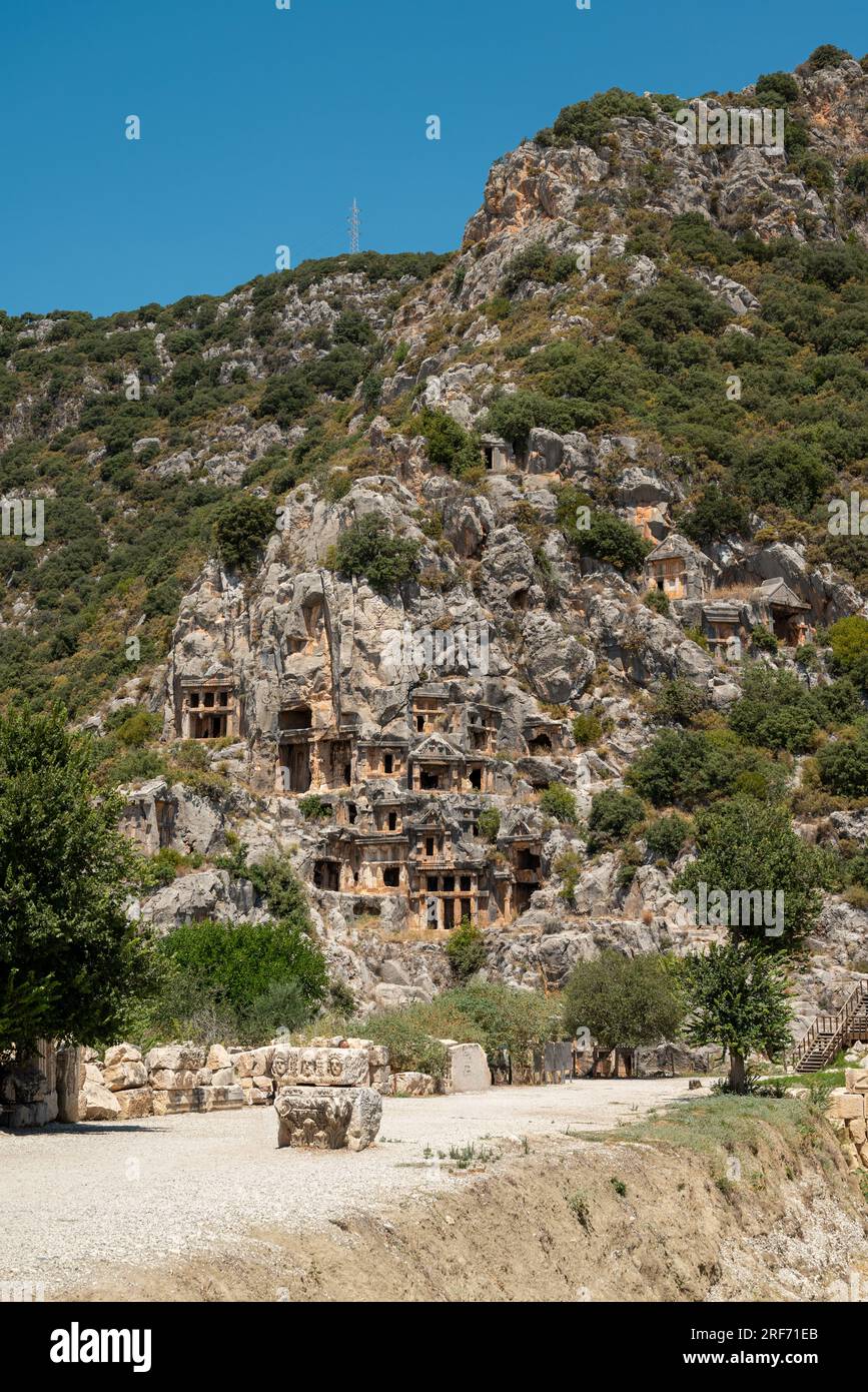 The ruins of the amphitheater and ancient rock tombs in the ancient city of Myra in Demre ...