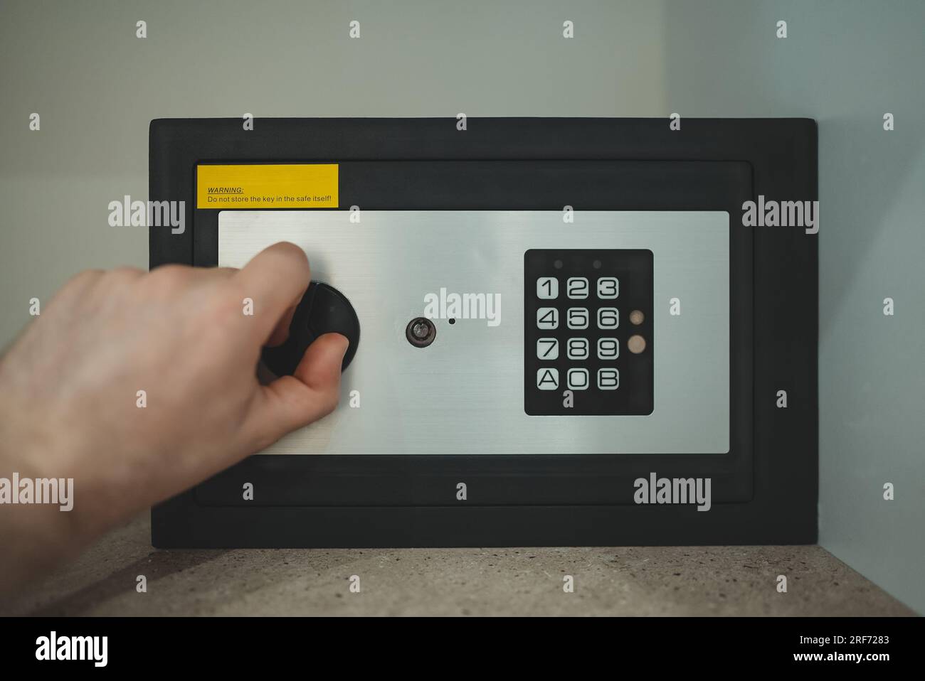Man opening safe numerical keypad hi-res stock photography and images - Alamy