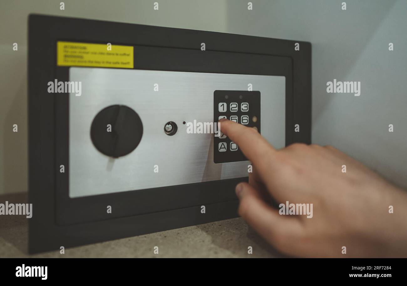 Man opening safe numerical keypad hi-res stock photography and images - Alamy