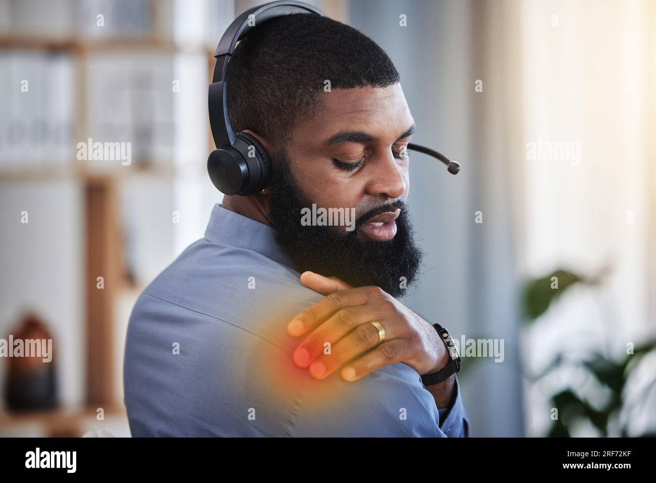 Call center, customer support and black man with shoulder pain, injury ...