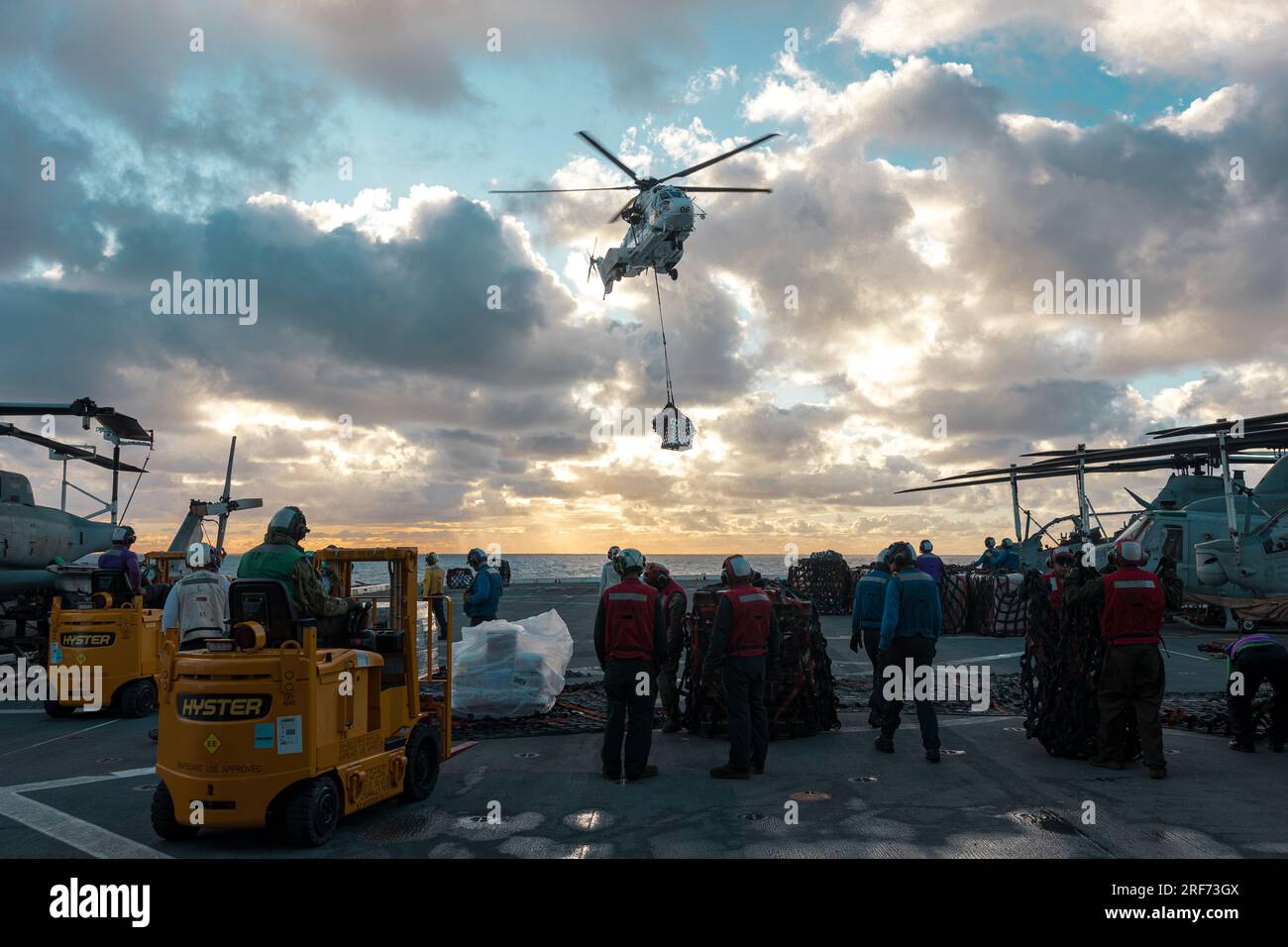 A U.S. Navy sailor guides an EC225 Super Puma helicopter delivering ...