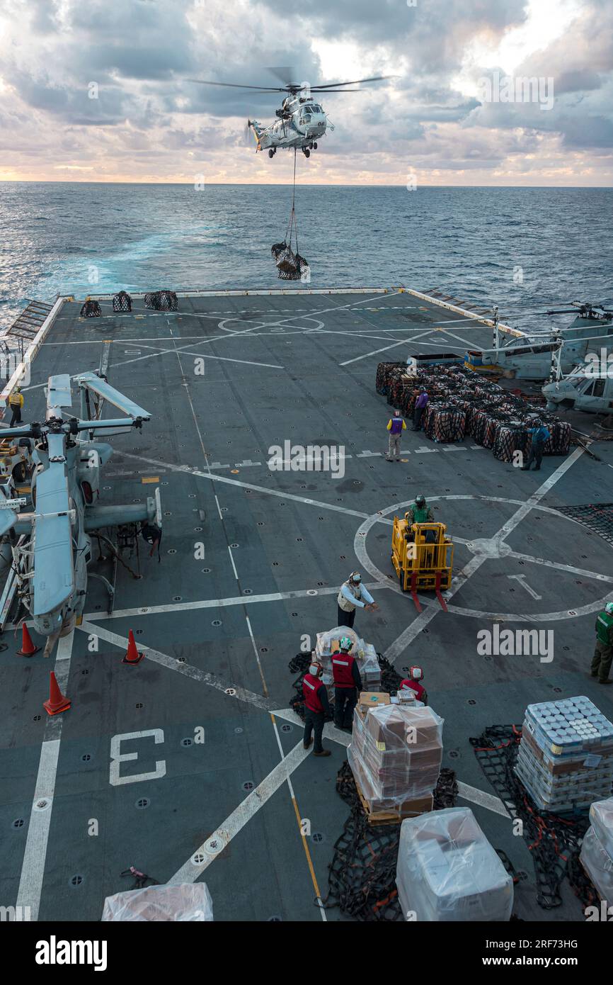 A U.S. Navy sailor guides an EC225 Super Puma helicopter delivering ...