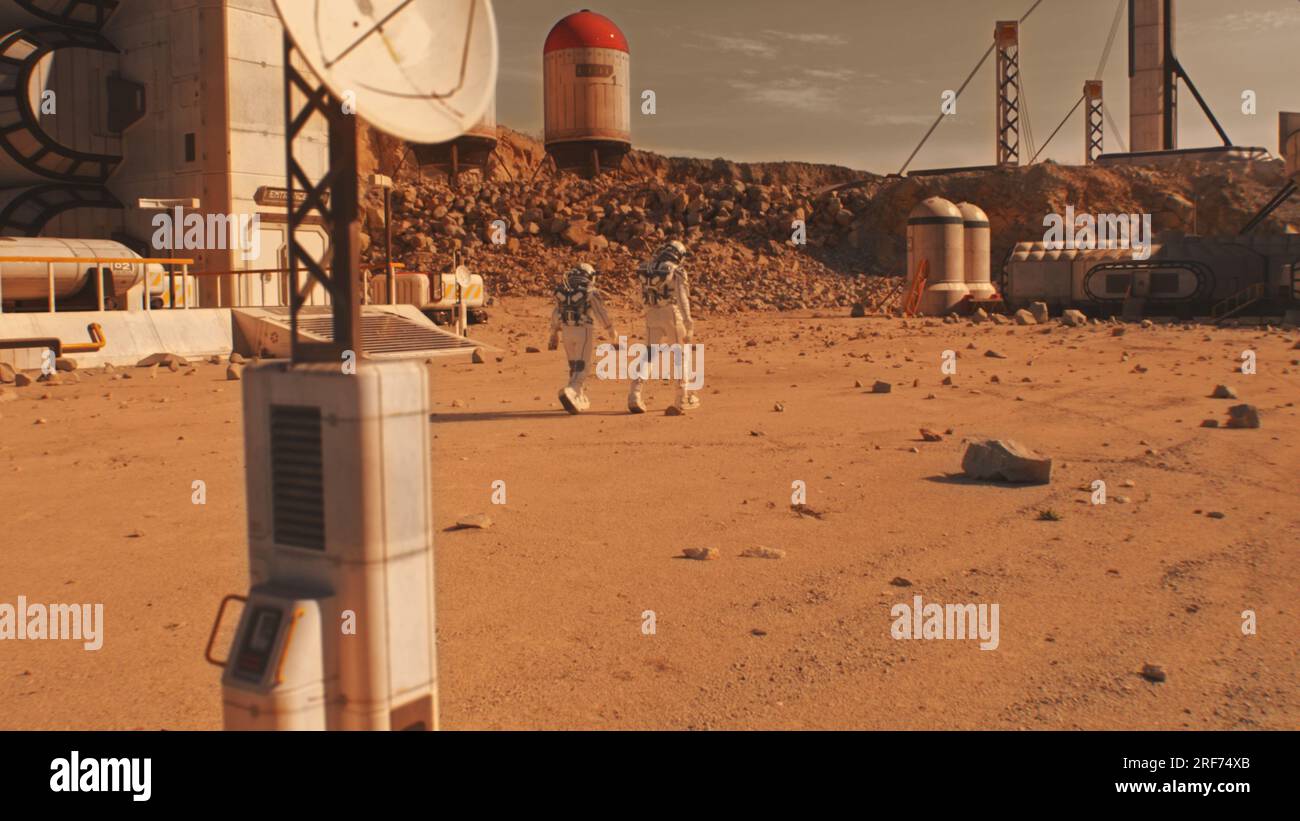 Two astronauts, scientists in spacesuits walk on Mars surface. Research ...