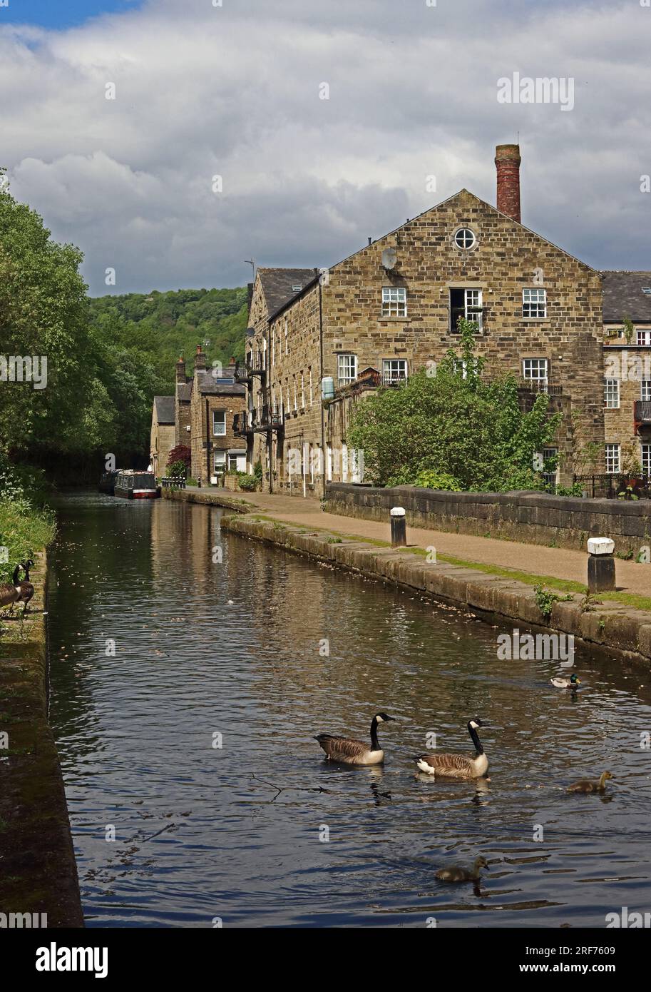 Rochdale canal with narrow boat and converted old mill buildings ...