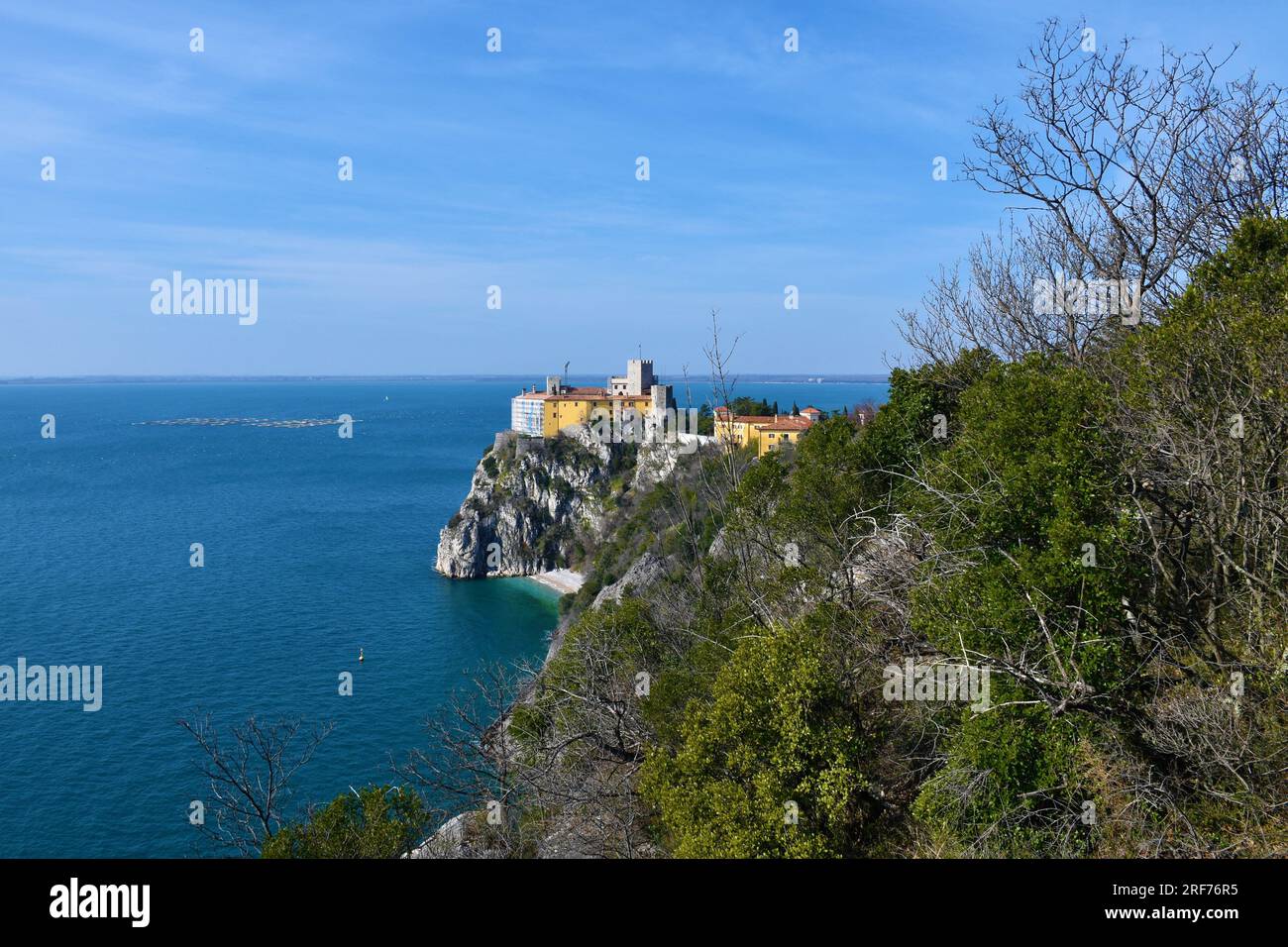 View of Castello di Duino at Riserva naturale delle Falesie di Duino on a cliff above the ...