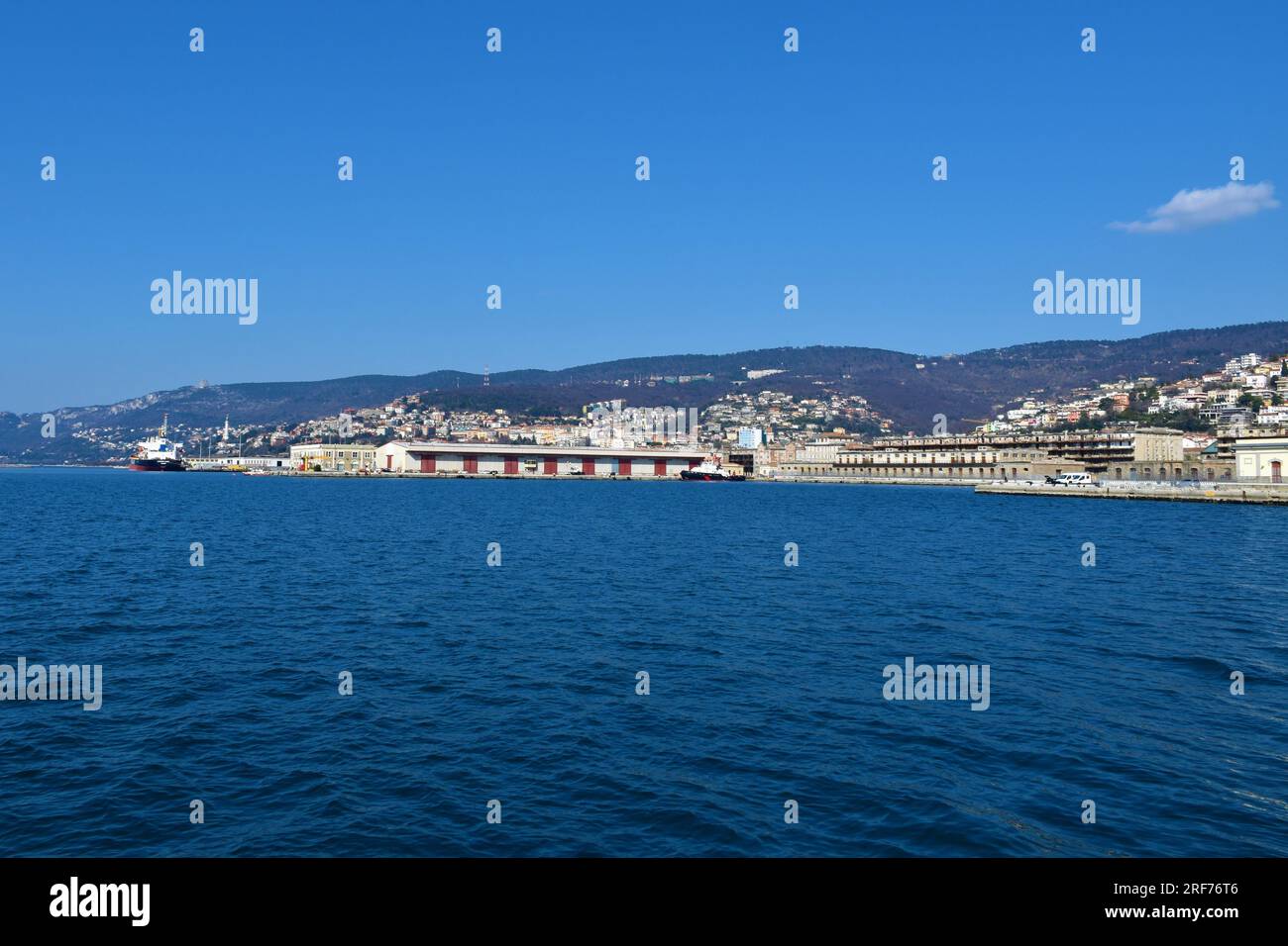 Port with a ship in the city of Trieste in Friuli Venezia Giulia region ...