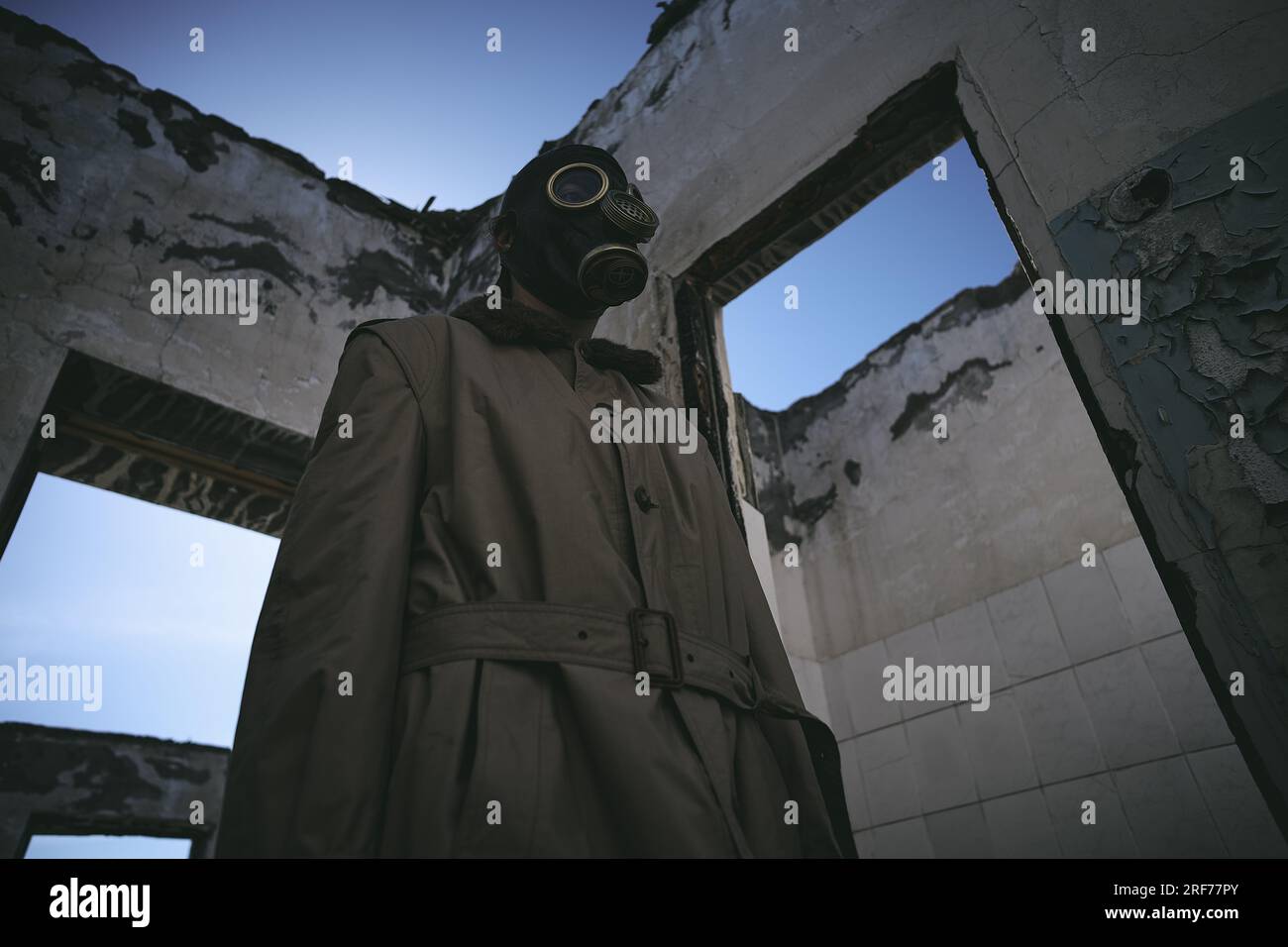 A man in gas mask walking inside an old building, low angle shot, good ...