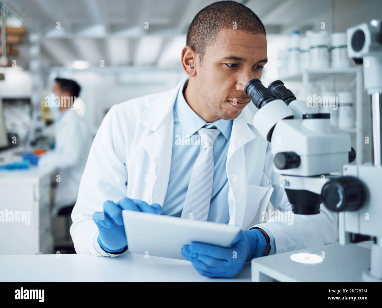 Microscope analysis, man and laboratory scientist working on healthcare research, pharma project ...