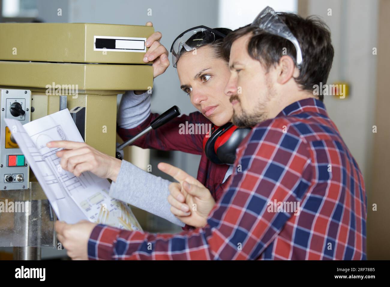 controlling work of female apprentice on stationary drilling machine ...